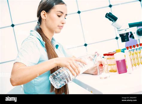Young Woman In The Laboratory Measures The Acidity Of Drinking Water Using A Rapid Test Stock