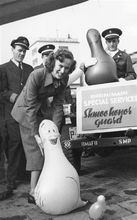 Pilots And A Flight Attendant Present The Inflated Shmoo Shaped Balloons At Rhein Main Airport