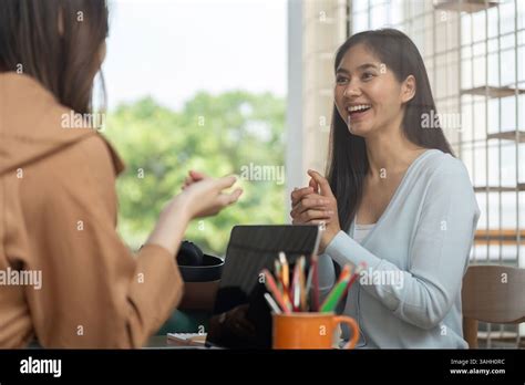 Collaboration And Study Session Two Students Engaged In An Animated