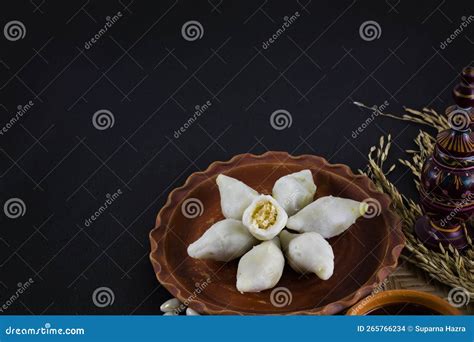 Puli Pithe Or Bengali Rice Flour Dumplings With Coconut Fillings Served On A Clay Plate With