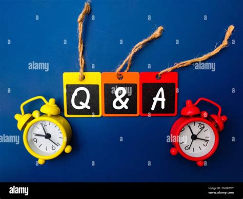 The Red And Yellow Alarm Clocks And Colored Wooden Boards With The Word