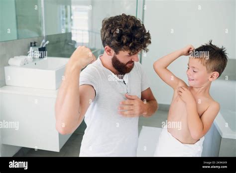 He Wants Muscles Just Like Daddy A Young Handsome Father And His Adorable Little Boy Flexing