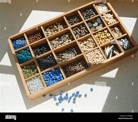 Close Up Of Sectioned Storage Box With Variety Of Ceramic And Wooden