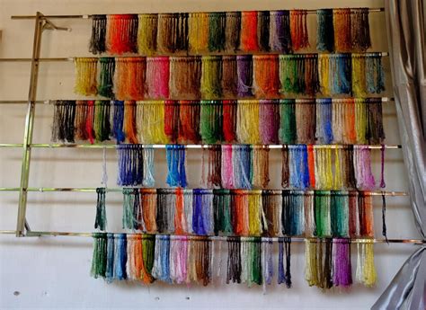 Premium Photo Colorful Threads Hanging On Rack