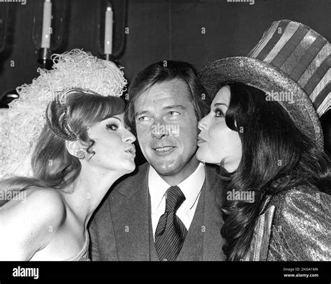 British Actor Roger Moore Gets A Kiss From Miss United Kingdom Marilyn