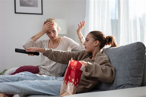 Mother Having Trouble With A Lazy Teenager Girl At Home While Watching