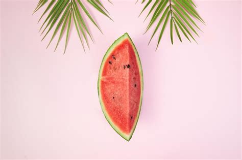 Premium Photo High Angle Shot Of A Slice Of Watermelon And Leaves On A Pink Surface