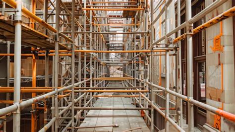 A Narrow Enclosed Passageway Formed By Scaffolding And Temporary
