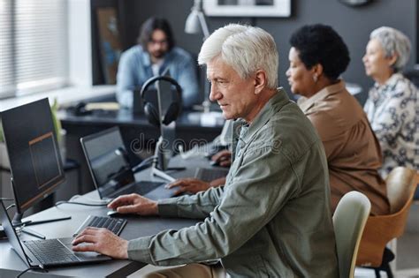 White Haired Man Using Computer In Programming Class For Seniors Stock