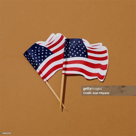Two Small Us Flags On A Brown Background Photo Getty Images