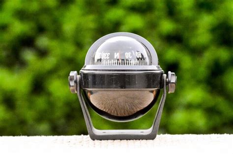 Premium Photo Close Up Of Compass On Table Against Trees