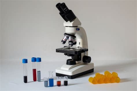 A Microscope And Test Tubes Placed Next To Oranges In A Scientific Setting A Microscope And