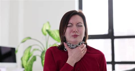 Woman With An Iron Chain Around Her Neck And A Sore Throat Stock Video