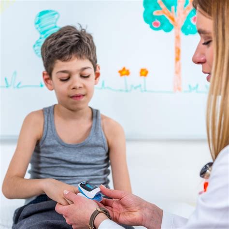 Premium Photo Female Doctor Examining Boy At Clinic