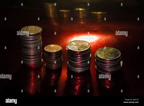 Fstack Of Coins On A Dark Red Background With Mirror Reflection Stock