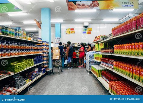 A Typical Grocery Checkout Counter Filled With Food And Disinfectant