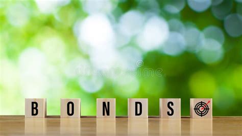 Bonds Word In Wooden Blocks With Coins Stacked In Increasing Stacks