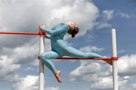 Premium Photo Acrobat Girl In A Blue Suit On The Street