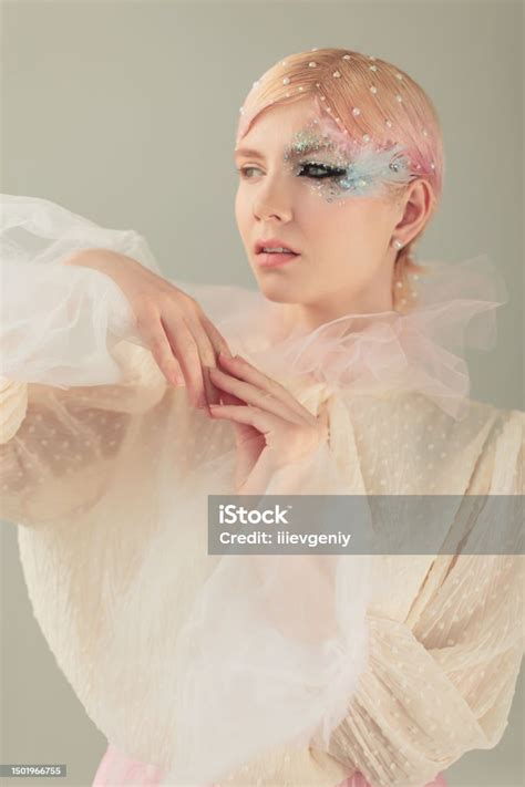 Blonde Girl In White Blouse In Studio On White Background Short Pink