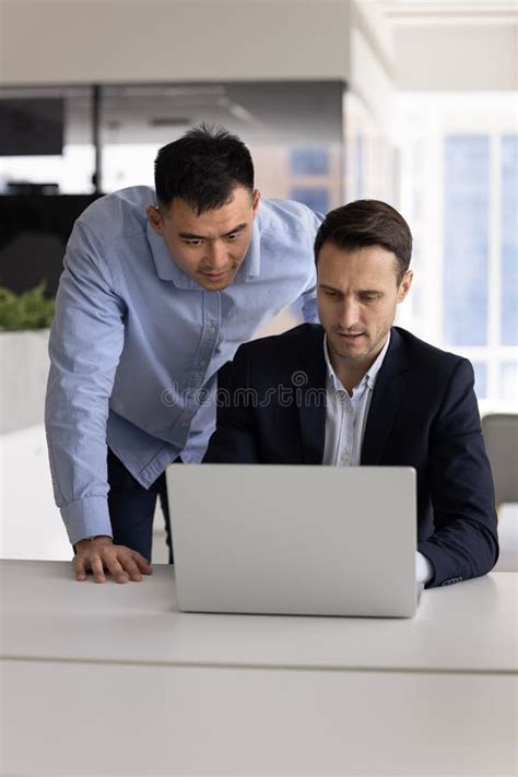 Boss Watching Manager Work Result Standing At Employee Workplace Stock