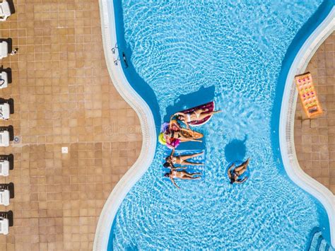 Beautiful Young Woman Lay Down Enjoying And Relaxing On An Inflatable Ice Cream Lilo In A Blue