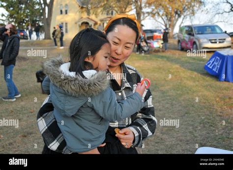 Jen Ancheta And Her Three Year Old Daughter Olive Get A Candy Cane From A Vendor At The Fort