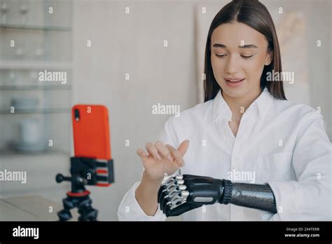 Young Woman With A Bionic Arm Checking The Time Technology Seamlessly