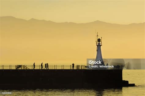 Silhouette Of People On Ogden Point Breakwater Lighthouse In Victoria