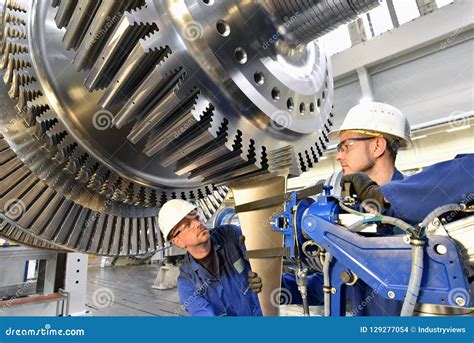 Workers Assembling And Constructing Gas Turbines In A Modern Ind Stock
