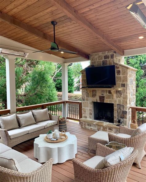 Beautiful Covered Deck With Stacked Stone Fireplace And Seating Area