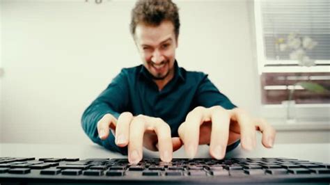 Man Doing Funny Faces While Typing Stock Footage Video 100 Royalty