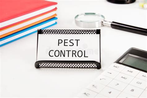 Pest Control Written On A Business Card In A Stand On A White