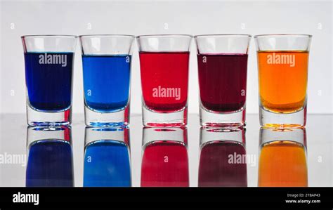 Small Glasses Filled With Colorful Water Are Neatly Arranged On An