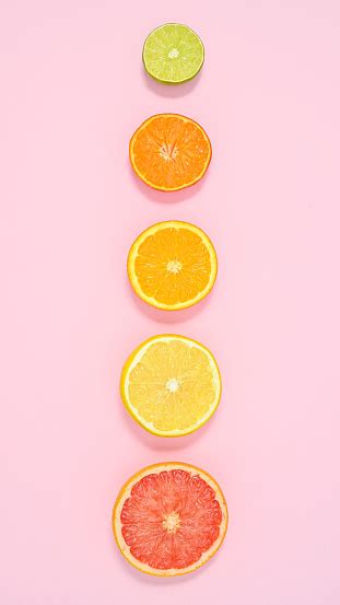 Creative Summer Fruits Pastel Pink Background With Sliced Citrus Flat