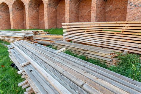 Premium Photo A Pile Of Lumber Is Stacked Up In A Brick Wall
