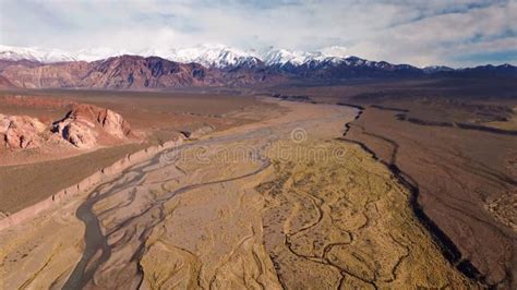 River Across The Steppes Near Uspallata Argentina With The Snowcapped