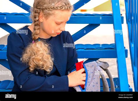 Schoolgirl Takes A Bar From A Backpack Concept School Meals Girl With A Chocolate Bar Pupil