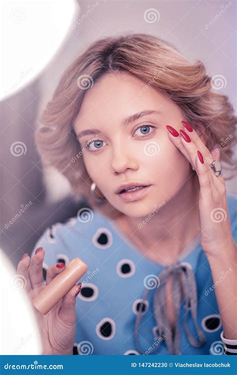 Close Up Of Appealing Woman Using Face Concealer Doing Makeup Stock