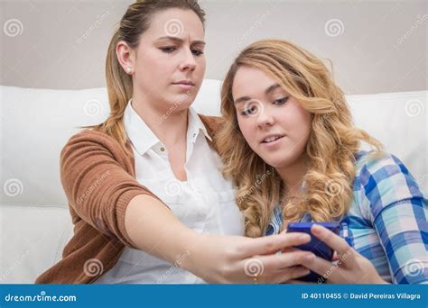 Surprised Mother When Looking Phone Of Daughter Stock Image Image Of