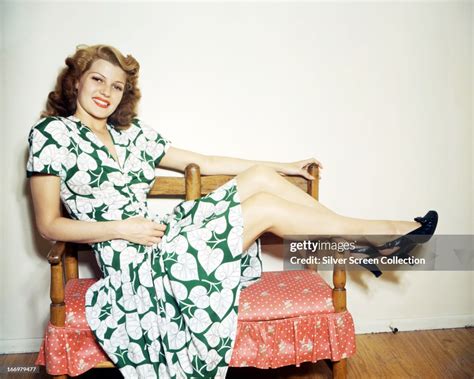 American Actress Rita Hayworth Reclining In A Green And White News