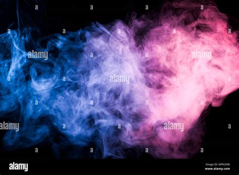 Dense Multicolored Smoke Of Pink Blue And Purple Colors On A Black
