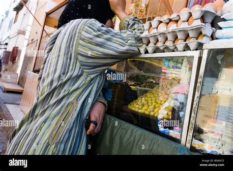 A Moroccan Woman Dressed In A Traditional Jalaba Shops In A Local Market In Casablanca Stock