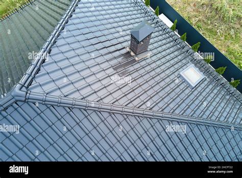 Closeup Of House Roof Top Covered With Shiny Ceramic Shingles Stock