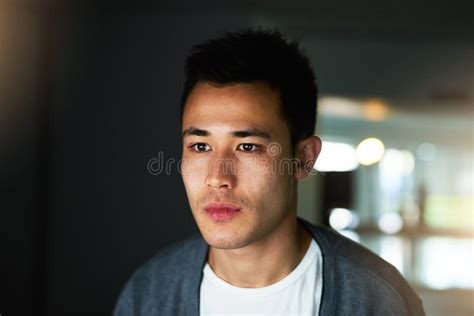 Long Hours Are Sometimes Required Shot Of A Handsome Young Male Programmer Working Late In His