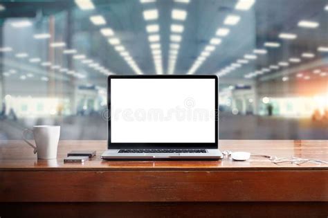 Laptop With Blank White Screen On Table And Workspace In Office Stock