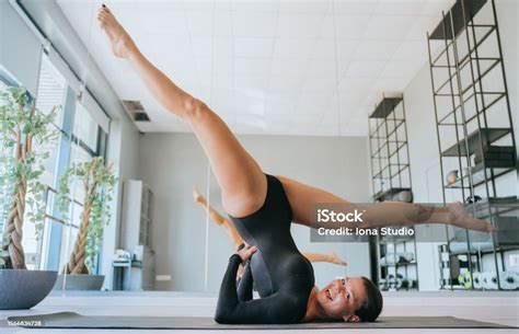 Cheerful Girl Doing Yoga Exercise On Mat At Fitness Young Flexible