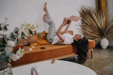 Premium Photo Young Hispanic Brunette Woman Laying On Sofa With Legs