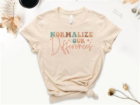 normalize our differences graphic by amerchshirts · creative fabrica