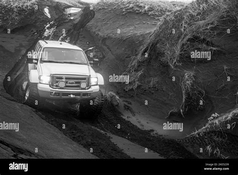 Offroad Vehicle Driving Through Extreme Terrain Stock Photo Alamy