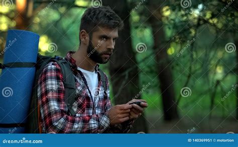 Man Orienteering In Forest Using Navigational Compass Survival
